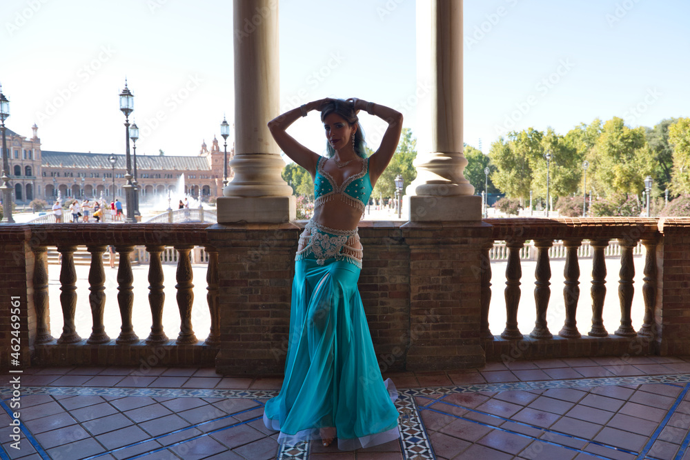 beautiful young belly dancer is posing for the camera in a photo shoot ...
