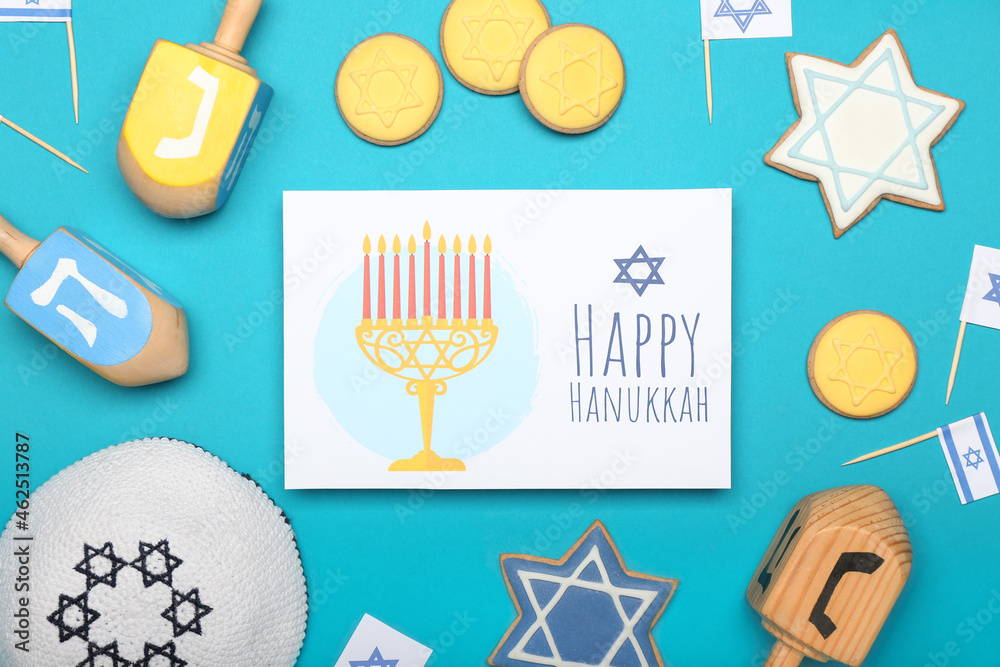 Different symbols of Hanukkah and greeting card on color background ...
