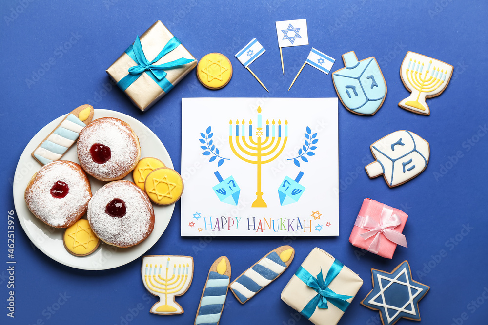 Different symbols of Hanukkah and greeting card on color background ...