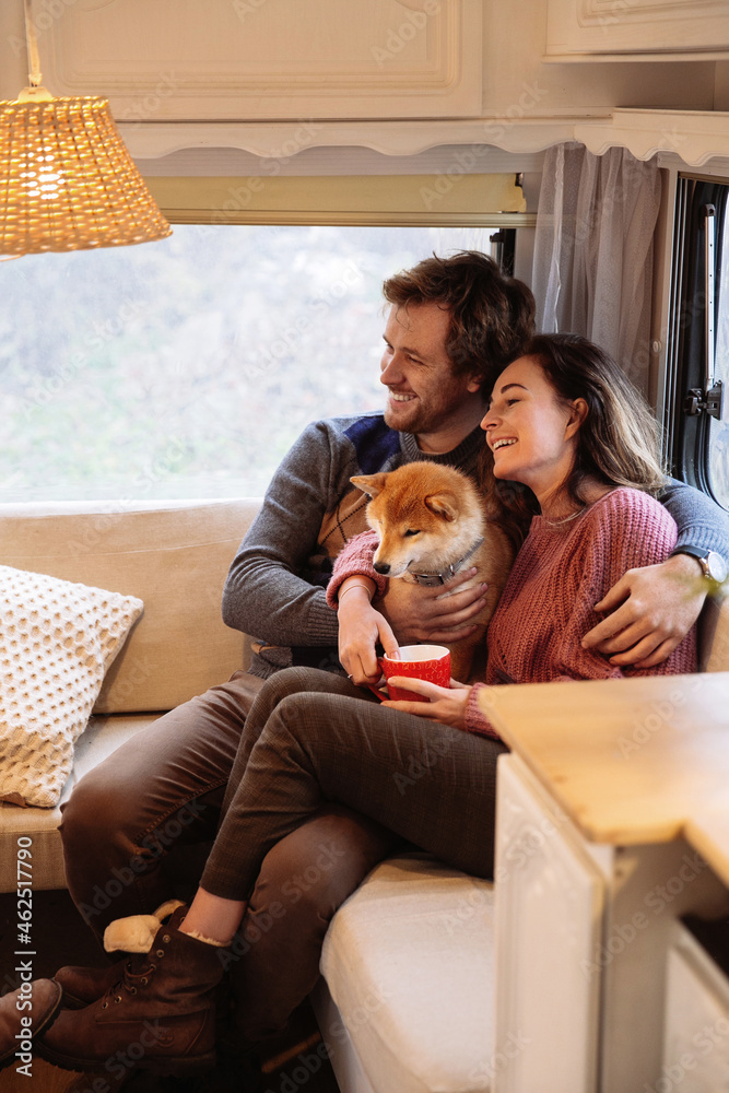 Childfree married couple inside trailer or camper sit on cozy sofa ...