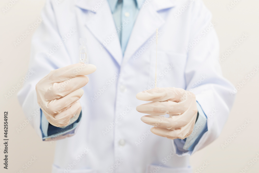 The doctor holding the SARS CoV-2 Rapid antigen test kit (ATK) with the ...