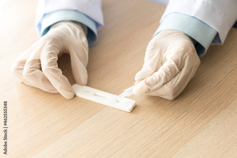Medical worker doctor holding swab sample collection kit, performing ...