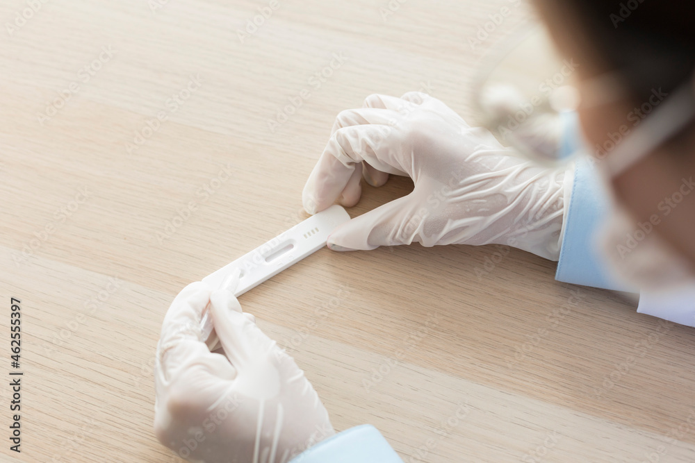 Medical worker doctor holding swab sample collection kit, performing ...