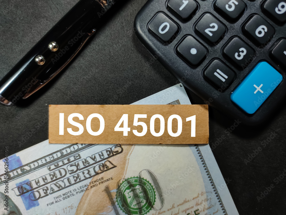 Calculator, pen and banknotes with word ISO 45001 Stock Photo | Adobe Stock