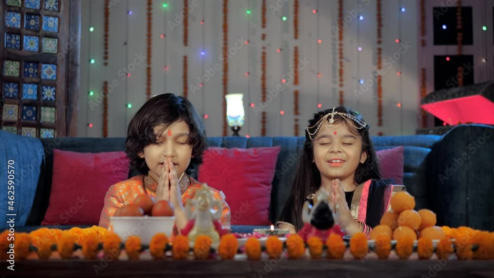 Young Indian brother and his cute sister doing Puja on the auspicious ...