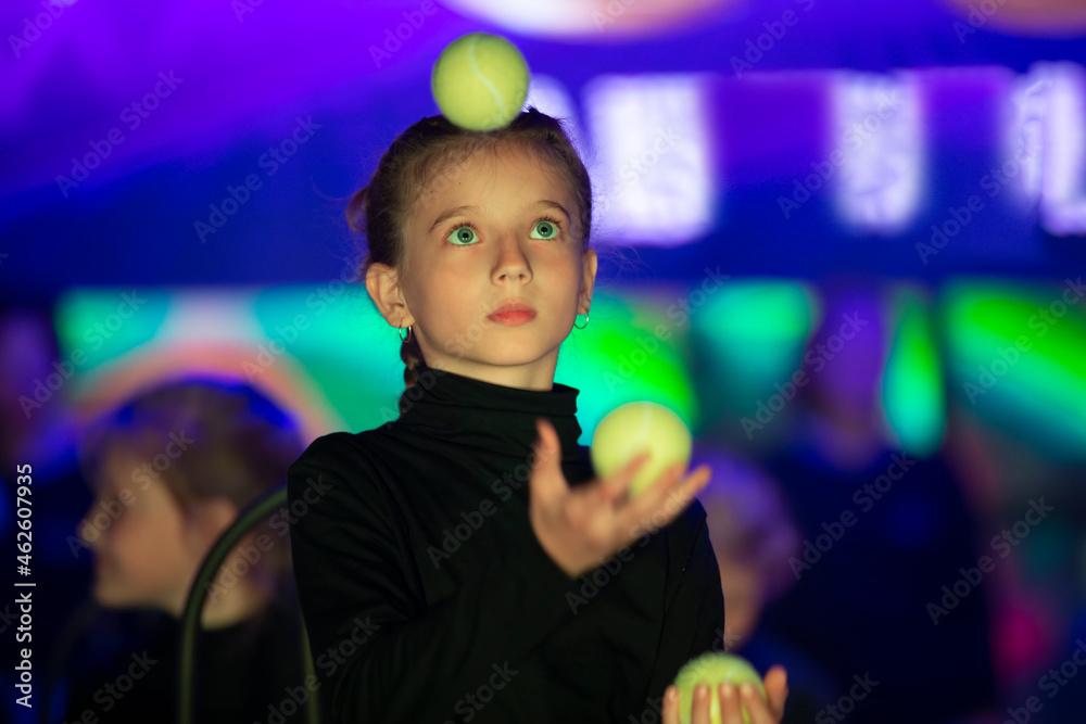 Little girl juggles balls. The circus art of juggling. Stock Photo ...