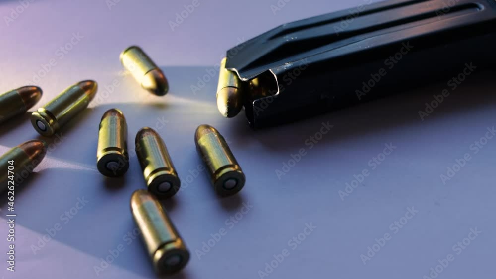 9mm caliber parabellum bullets isolated with grazing light next to a ...