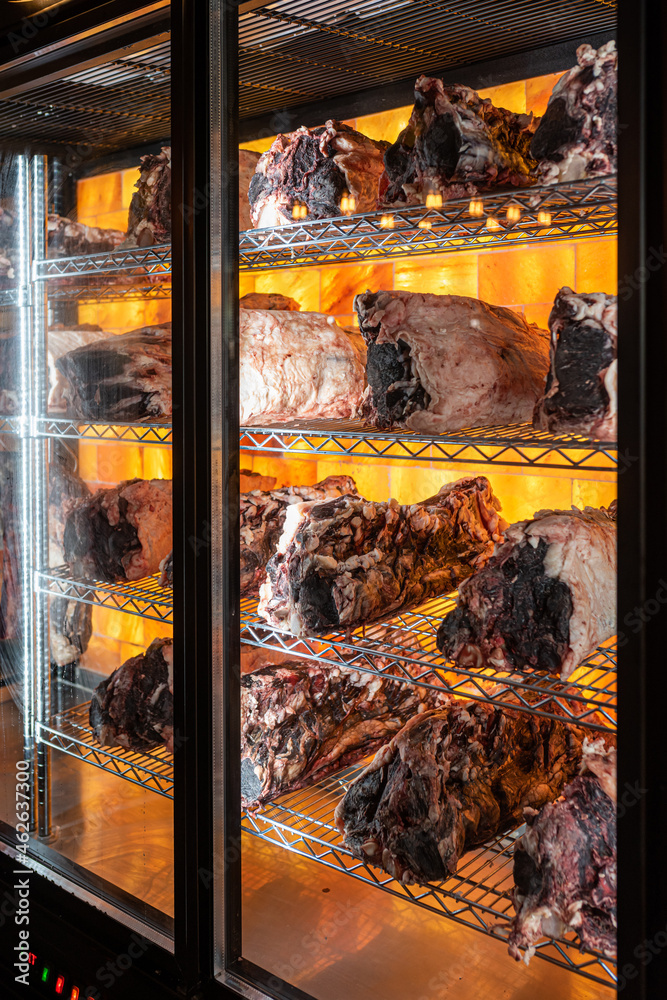 Beef hung and lined up in a dry aged beef cabinet Stock Photo | Adobe Stock