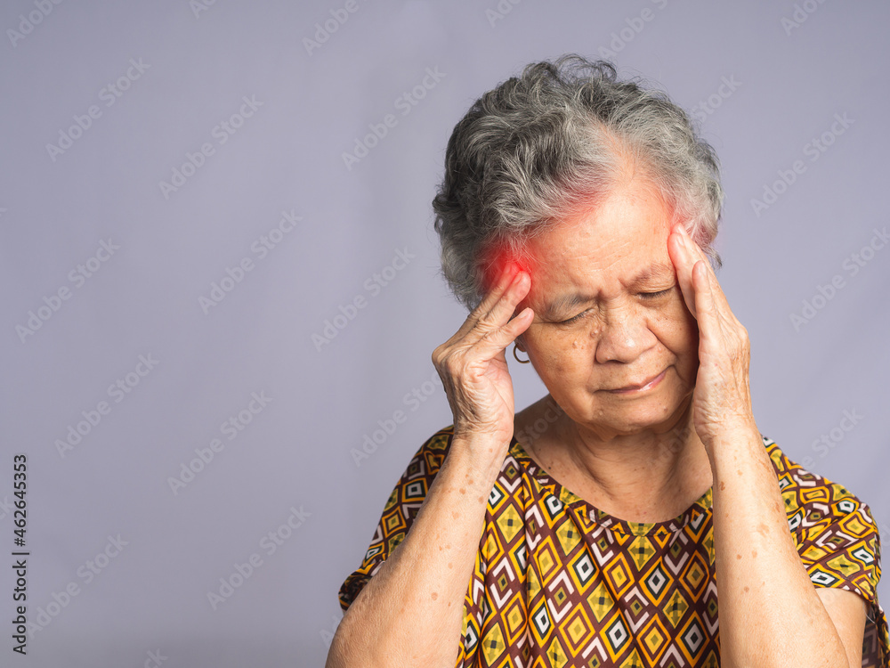 A senior woman who has a severe headache suffers from a stroke, brain ...