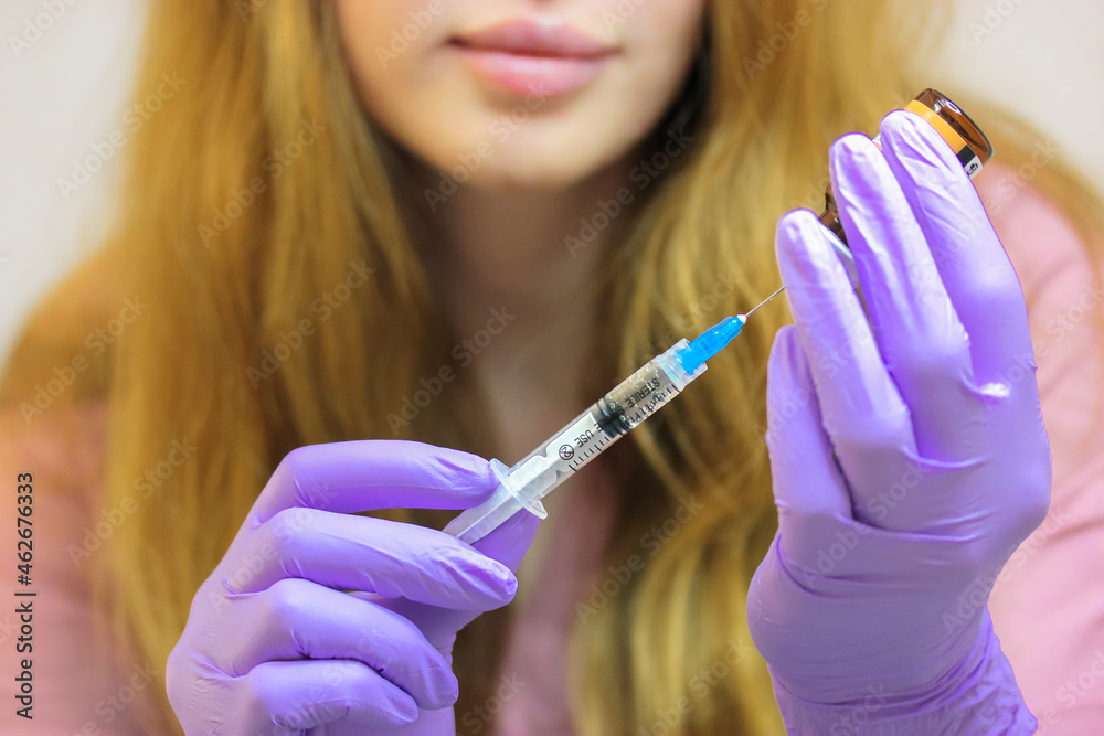 Syringe for injection with medicine in the hands of nurse or female ...