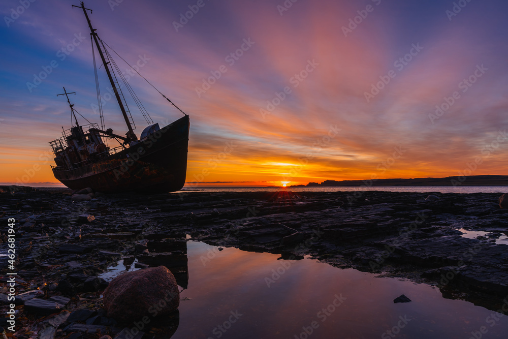 Stranded old fishing schooner at beautiful dawn. The old ship is ...