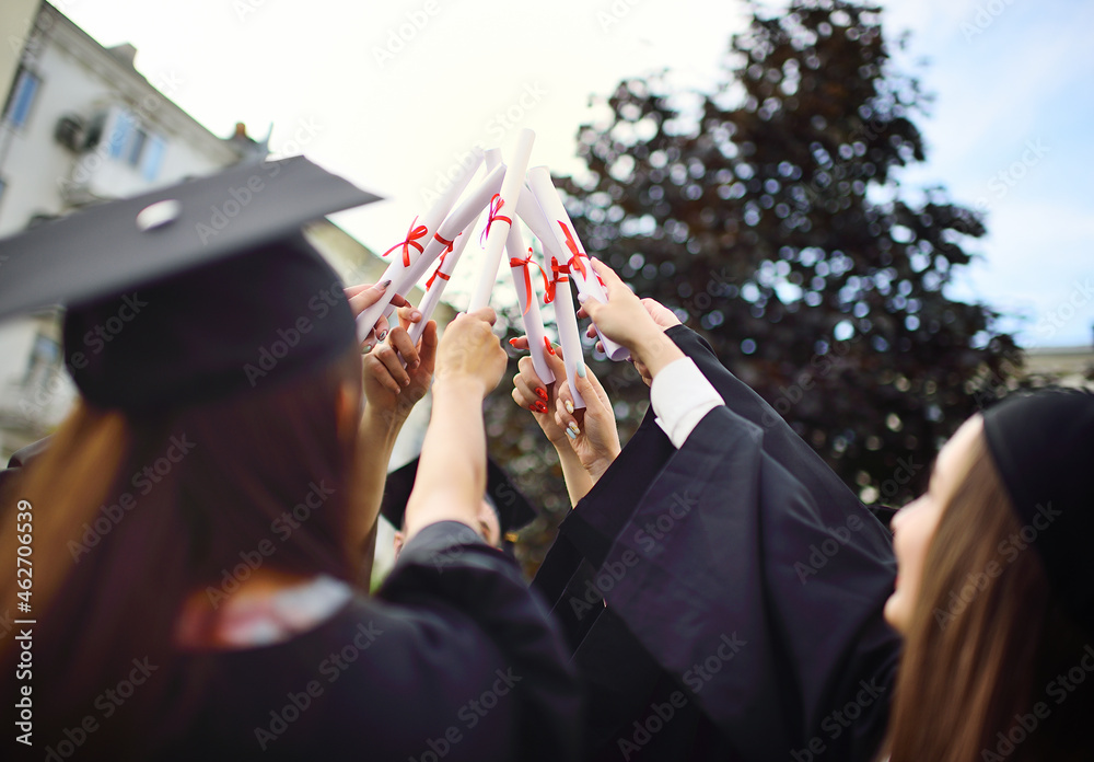 group of university graduates in student robes or mantle and square ...