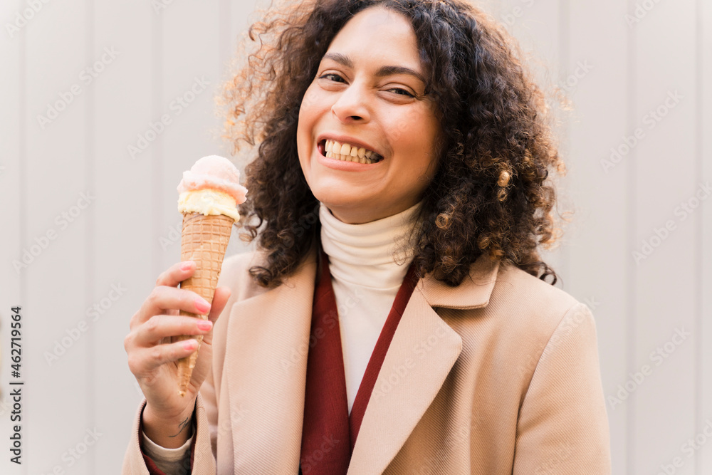 Porrait of happy woman eating an ice cream cone Stock Photo | Adobe Stock