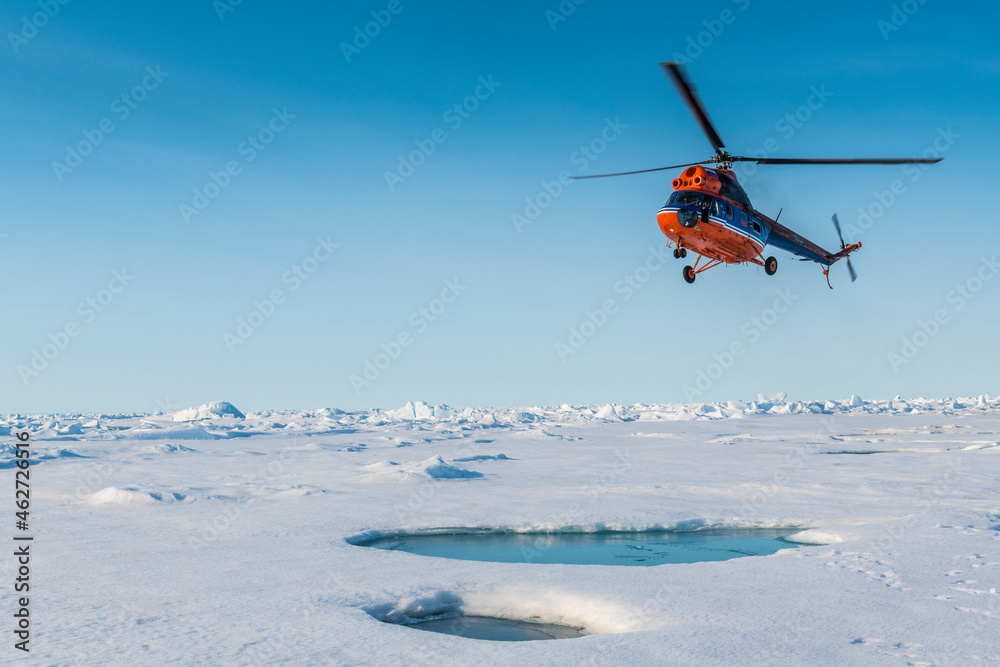Helicopter flying over melting ice at North Pole Stock Photo | Adobe Stock