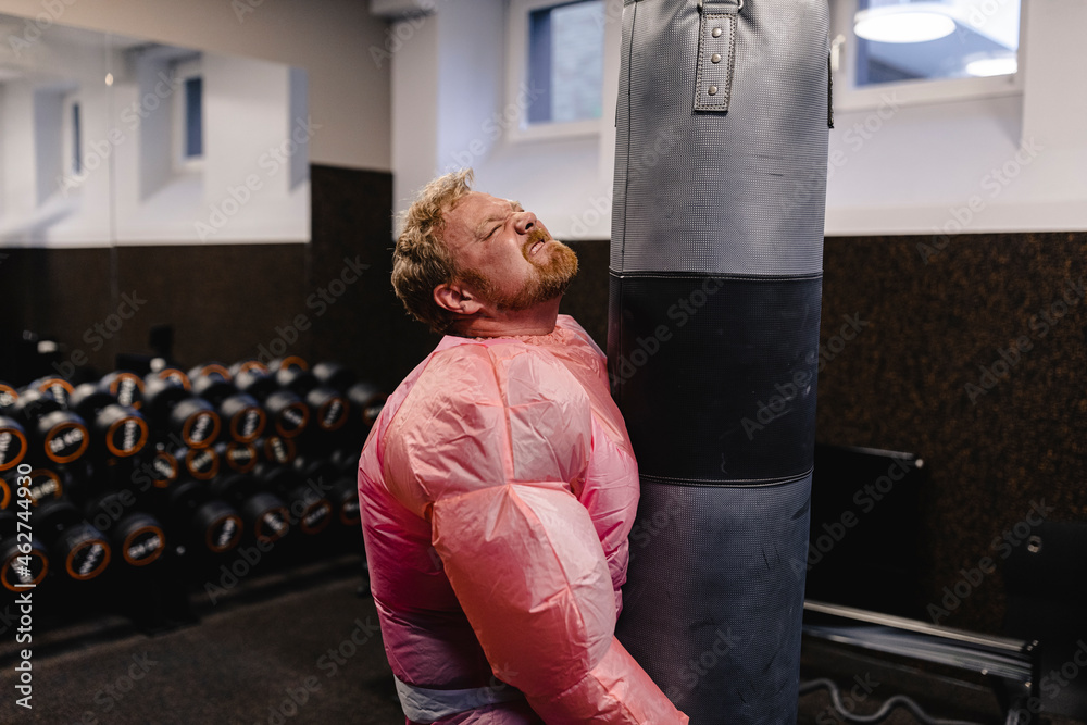 Man wearing pink bodybuilder costume practicing in gym Stock Photo ...