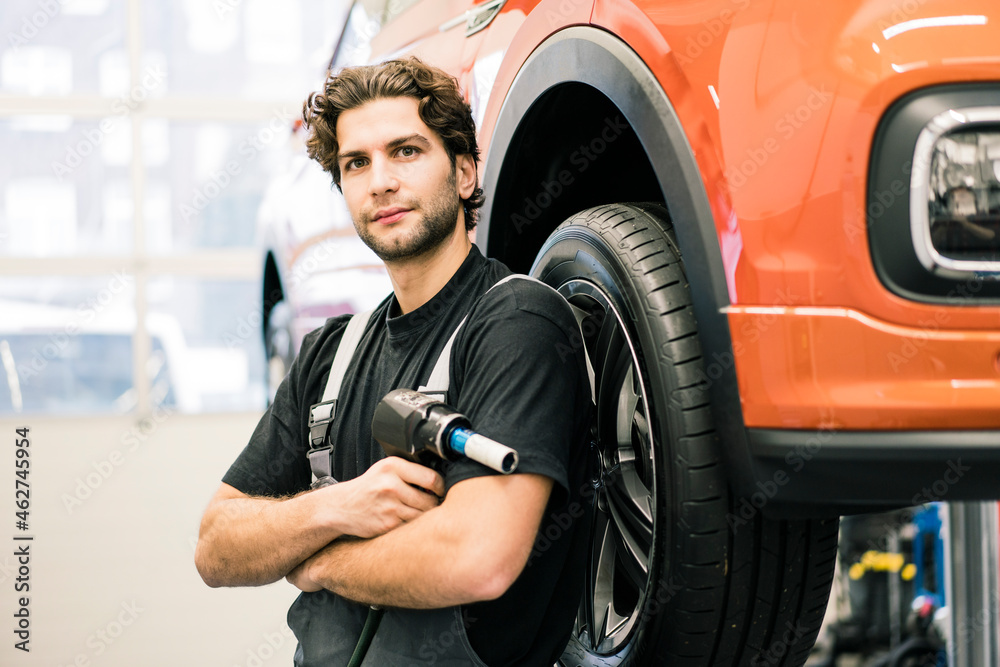 Portrait of a confident car mechanic in a workshop Stock Photo | Adobe ...