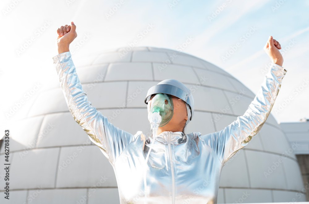 Woman in protective suit with oxygen mask and sunglasses cheering while ...