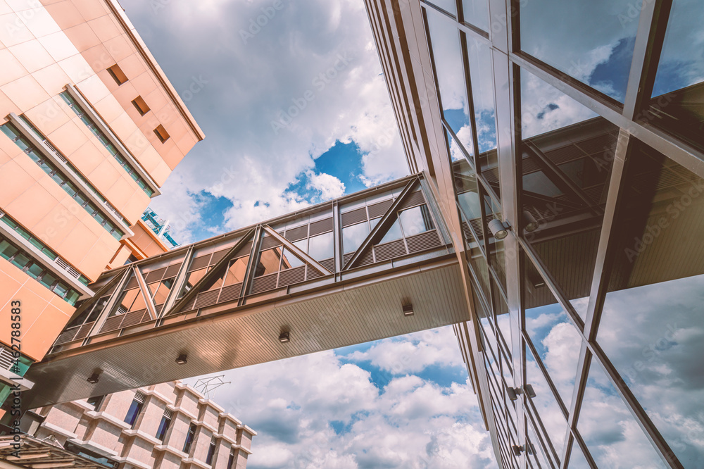 Sky bridge between two buildings between glass building and traditional ...