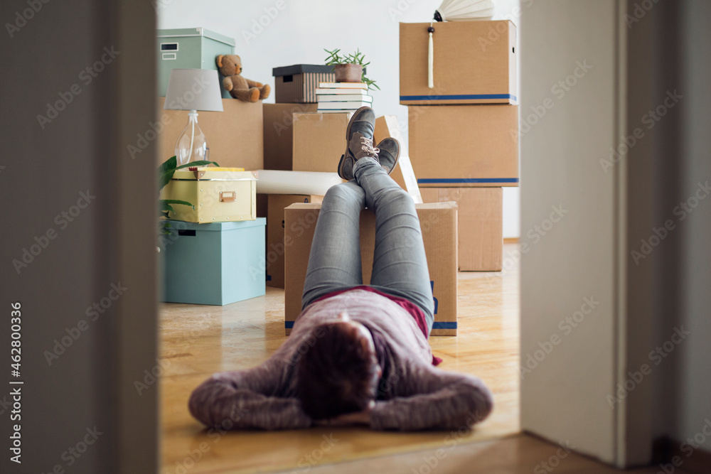 Woman relaxing surrounded by cardboard boxes in a new home Stock Photo ...