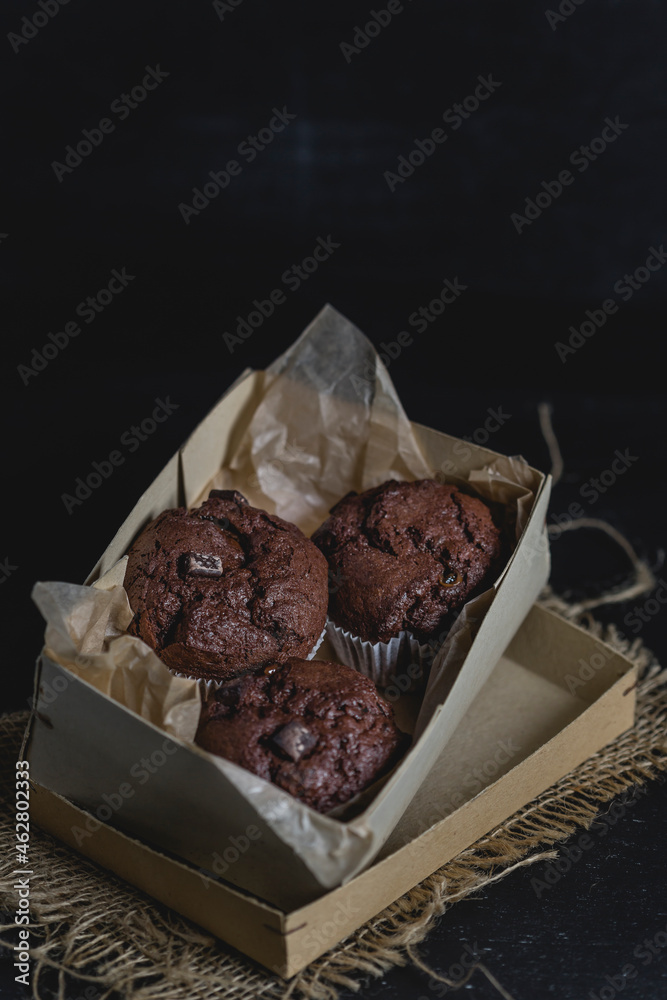 Chocolate muffins in a cardboard box Stock Photo | Adobe Stock