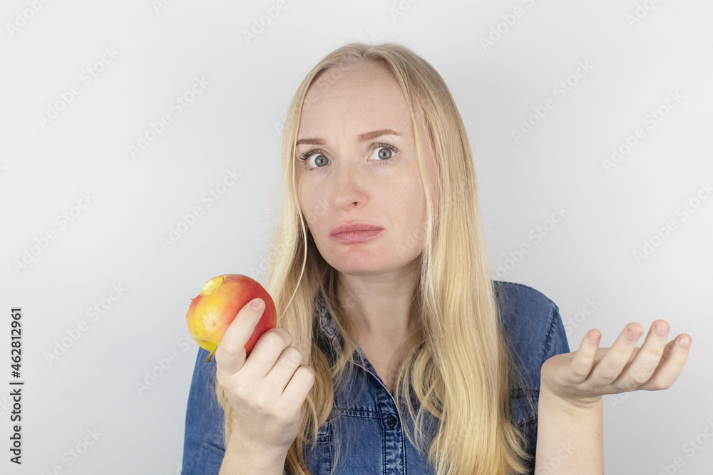 Loss of taste. A girl in front of a mirror eats a chocolate bar or an ...