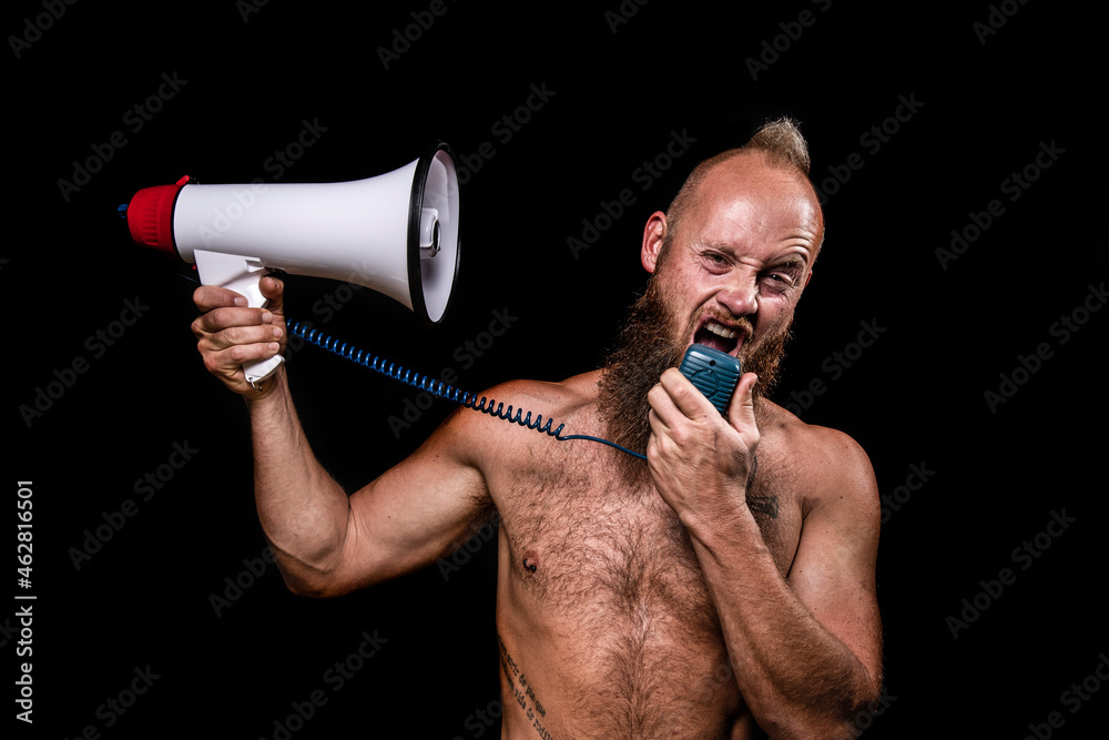 Frustrated male shirtless viking screaming on himself through megaphone ...