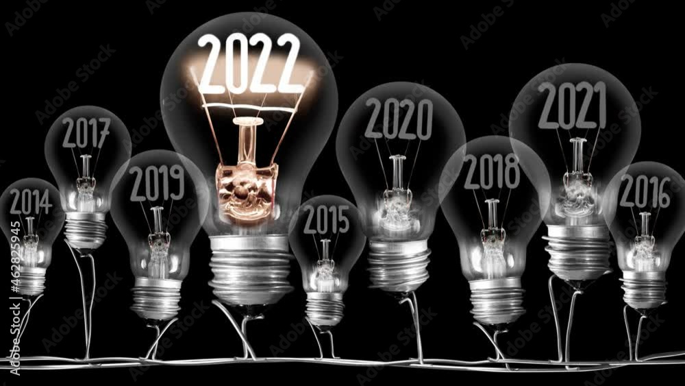 Shining light bulb with New Year 2022 and group of dark light bulbs in ...