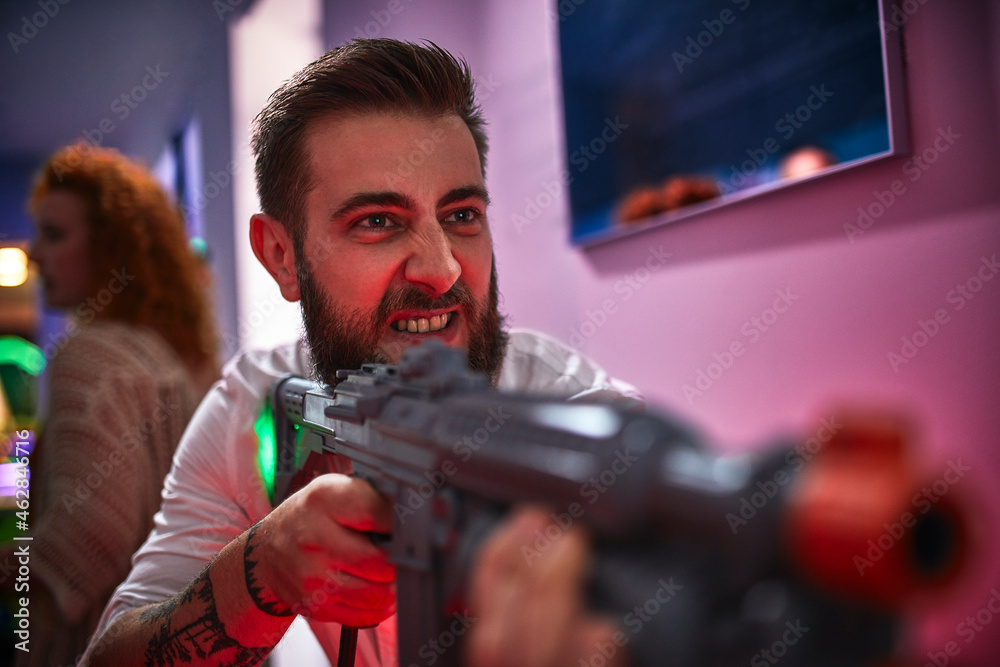 Aggressive man shooting with rifle in an amusement arcade Stock Photo ...