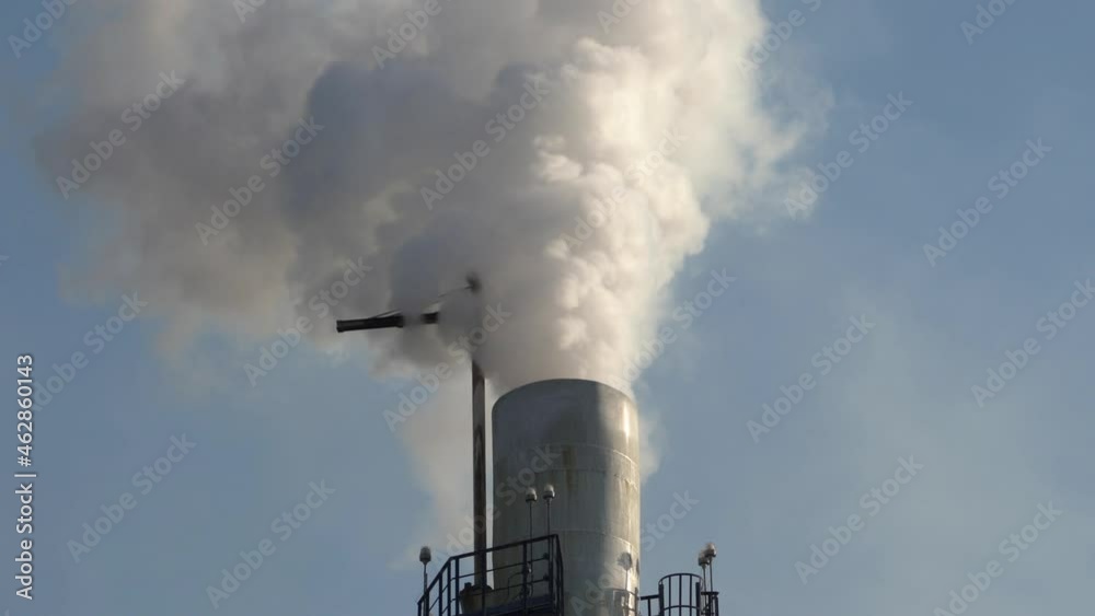 Smoke from chimney. Close-up. The steam rises. Smoke escapes from pipe ...