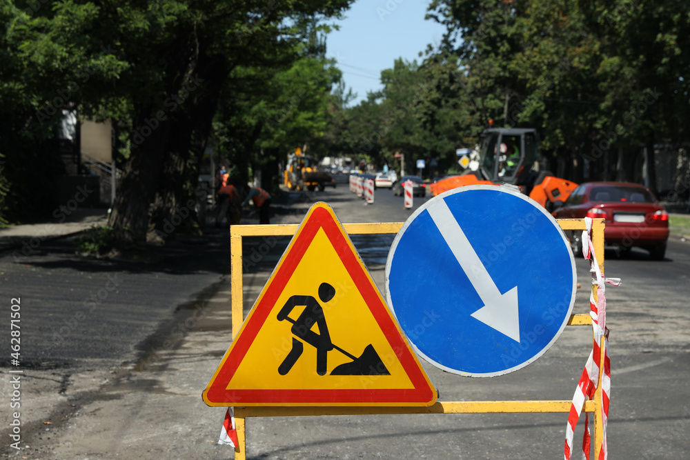 Barricade with traffic signs on city street. Road repair Stock Photo ...