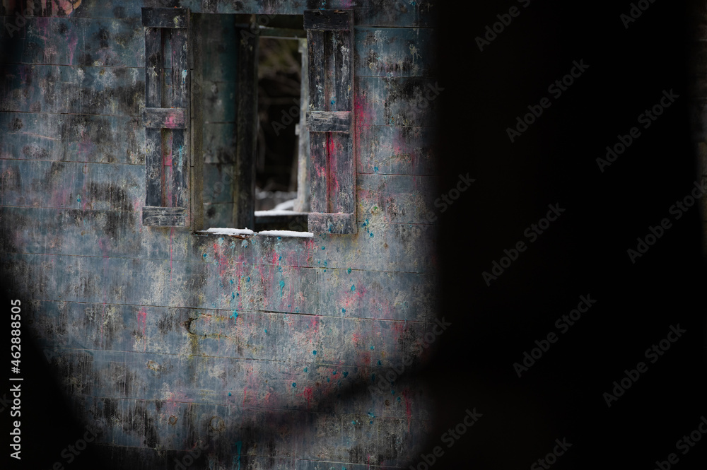 wooden plank wall of building covered with paint ball splatter one ...