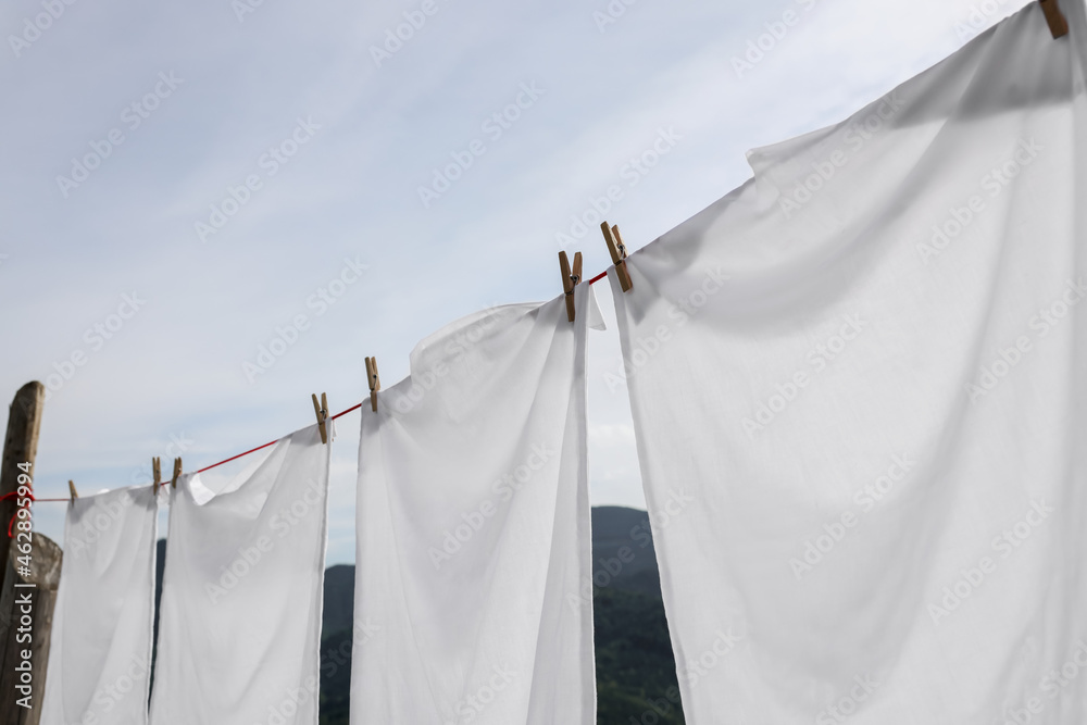 Washing line with clean laundry and clothespins outdoors Stock Photo ...