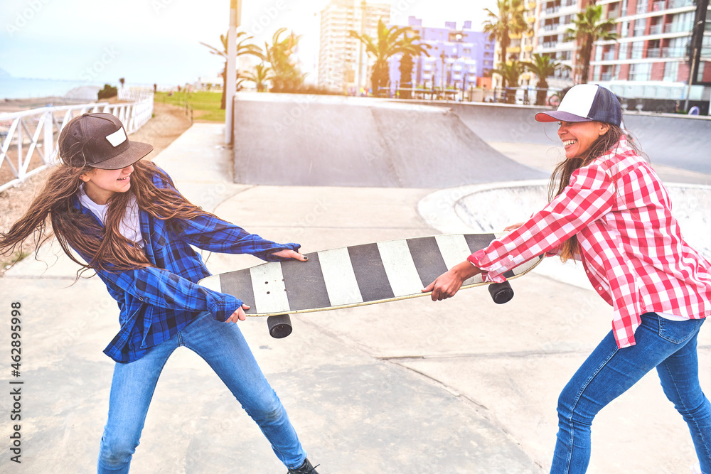 Angry girls fighting for a skateboard in skate park. friends doing ...