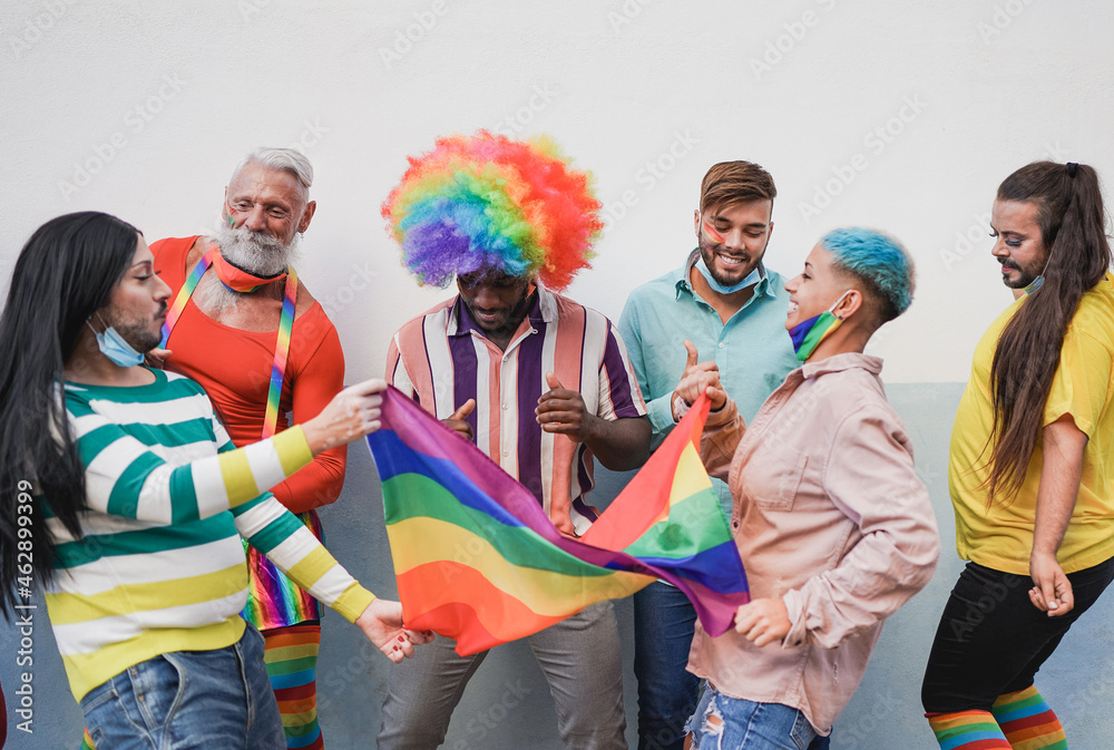 Multiracial people dancing at lgbt pride parade with rainbow flag while ...
