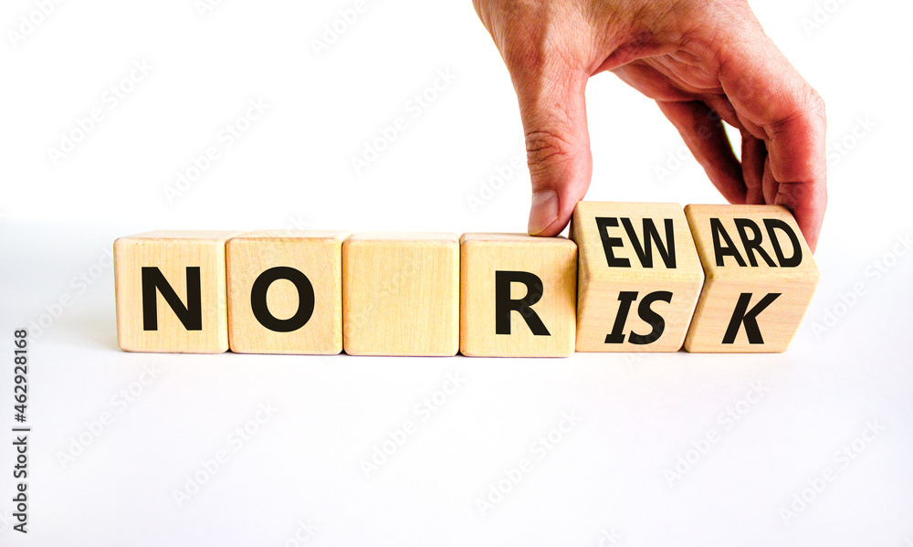 No risk and reward symbol. Businessman turns wooden cubes and changes ...