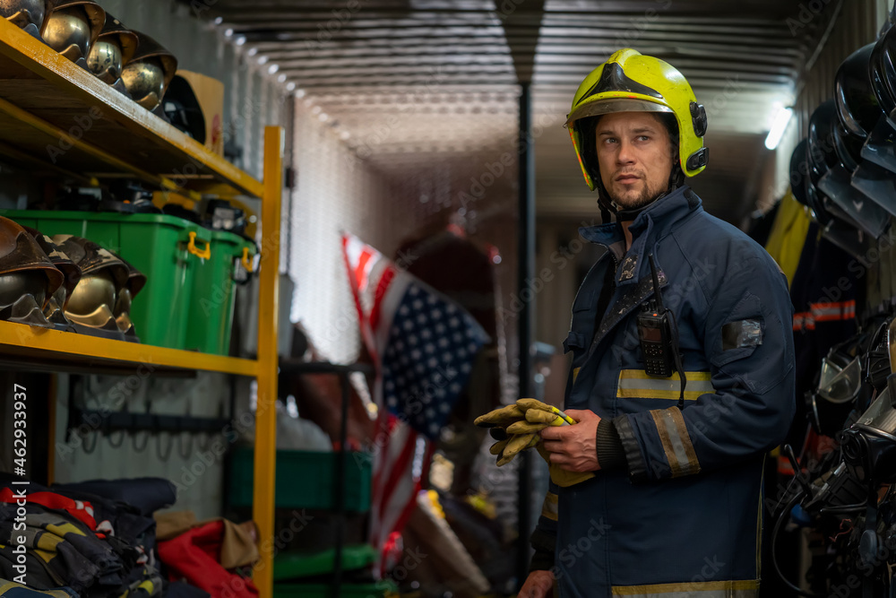 Firefighter with uniform and helmet standing at fire station,Fireman ...