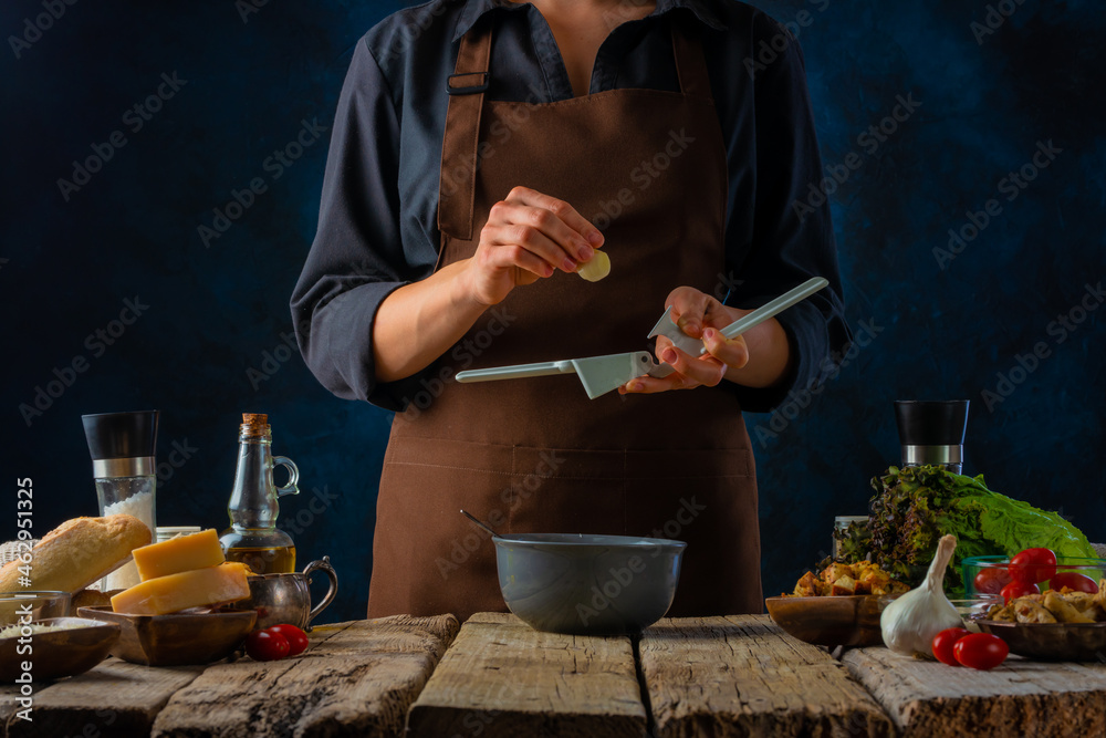 The chef prepares a classic Caesar salad. prepares mustard sauce ...