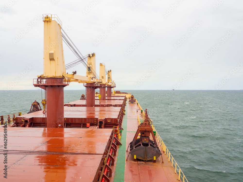 Dry bulk carrier ship with crane crab and towers at sea, deck view Stock Photo | Adobe Stock