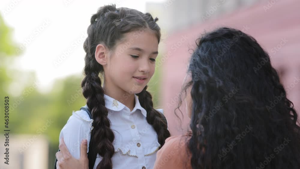Close-up caring unrecognizable mother brunette woman mom seeing off ...