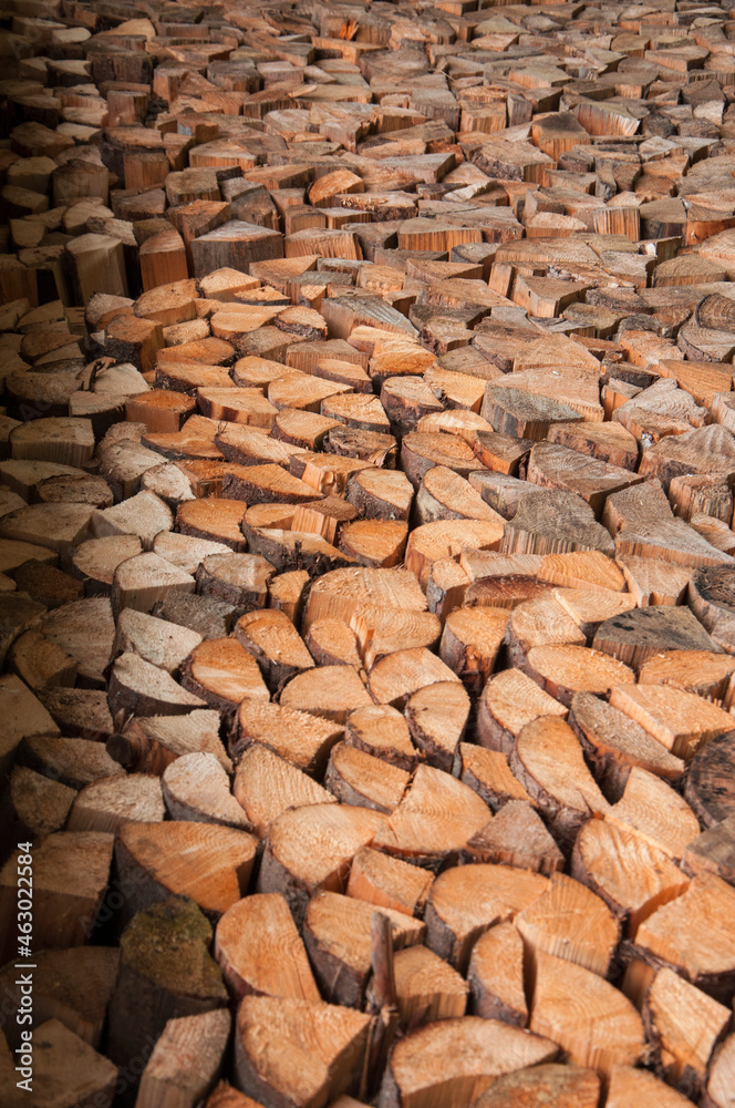 stacked chopped firewood. timber bars at a sawmill. wood background ...