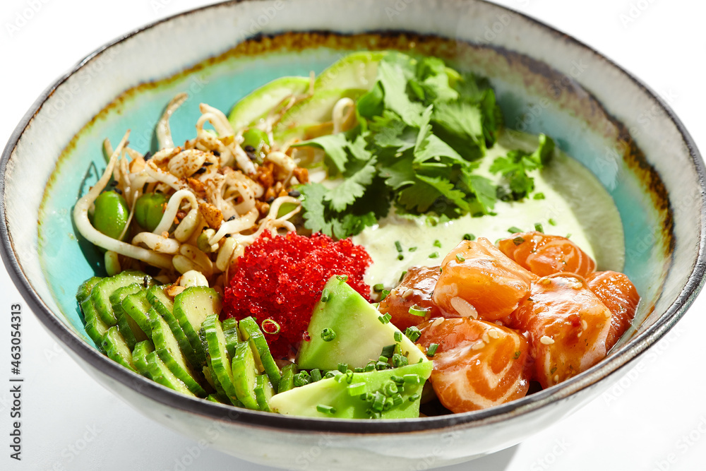 Healthy food - poke bowl with salmon, rice, cucumber, avocado, edamame ...