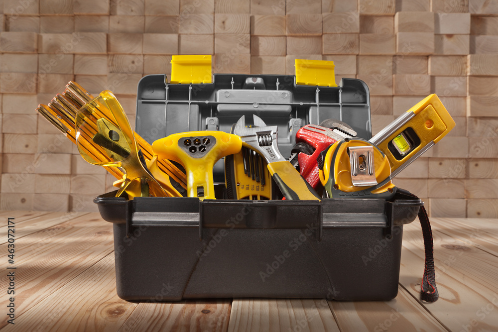 Various Work Tools In Little Black Toolbox. On Background Of Pile ...