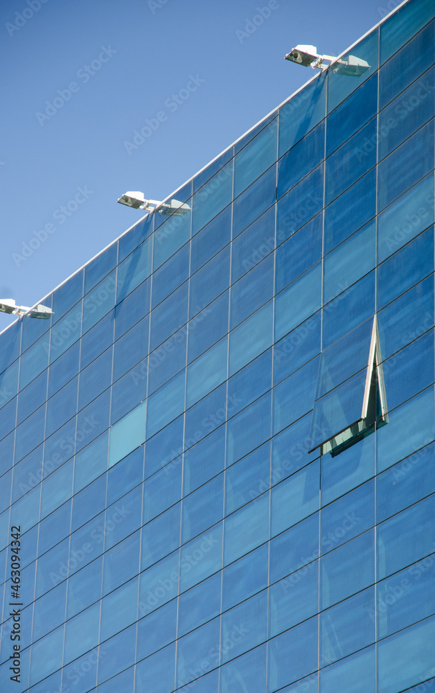 Facade of an office building with only one window open. Vertical size ...