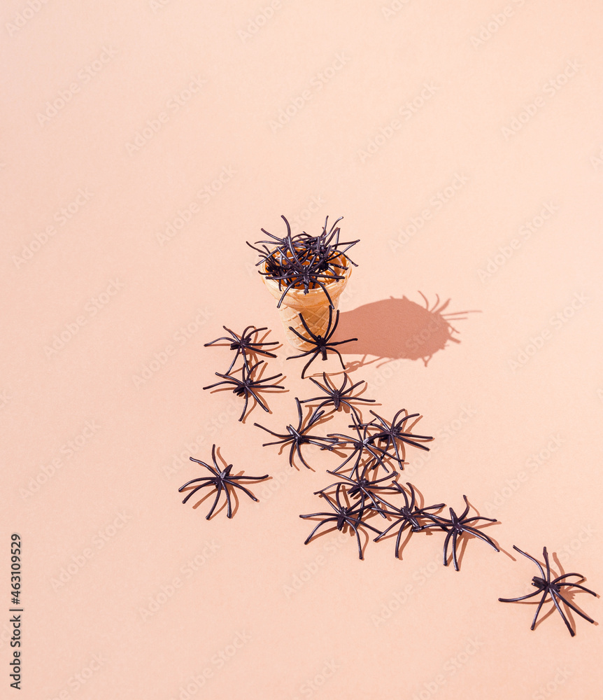 Spiders going out of an ice cream cone. Pastel beige background. Scary ...