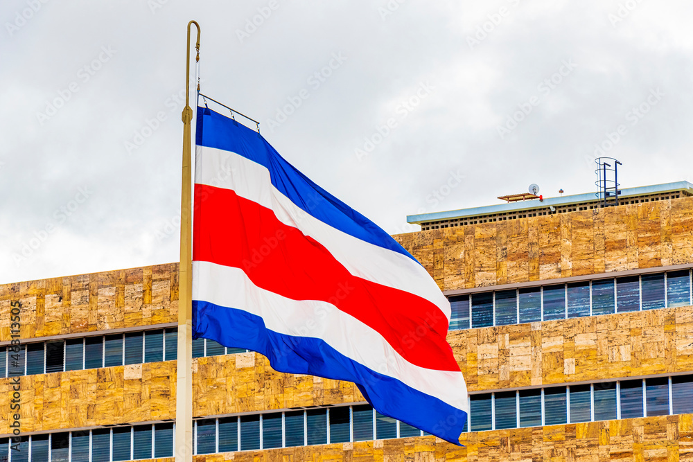 Flag of Costa Rica old buildings behind Costa Rican flag. Stock Photo ...