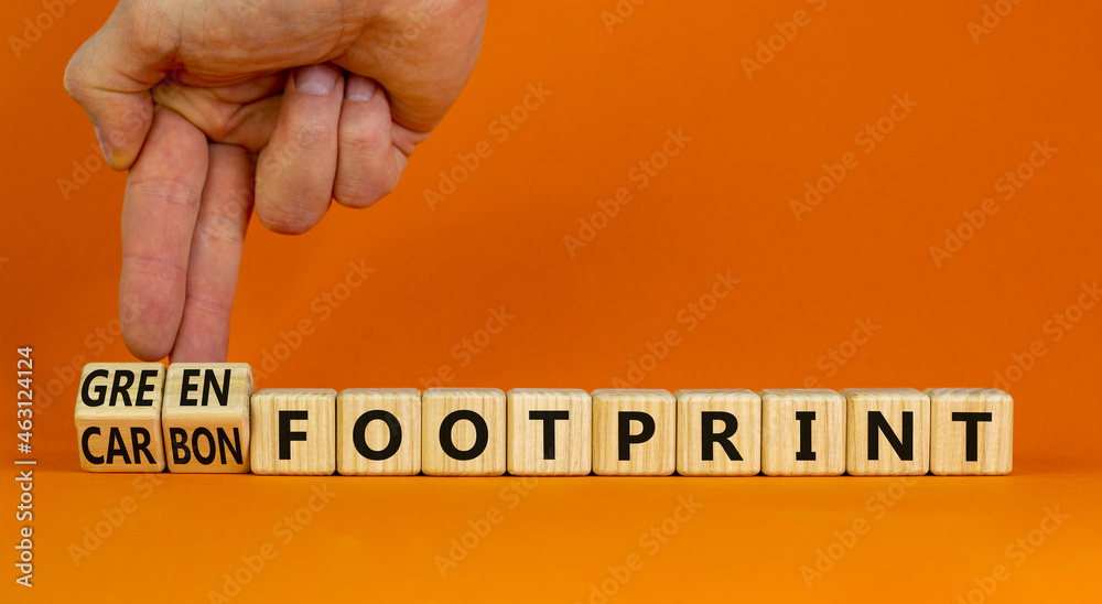 Green or carbon footprint symbol. Businessman turns wooden cubes and ...