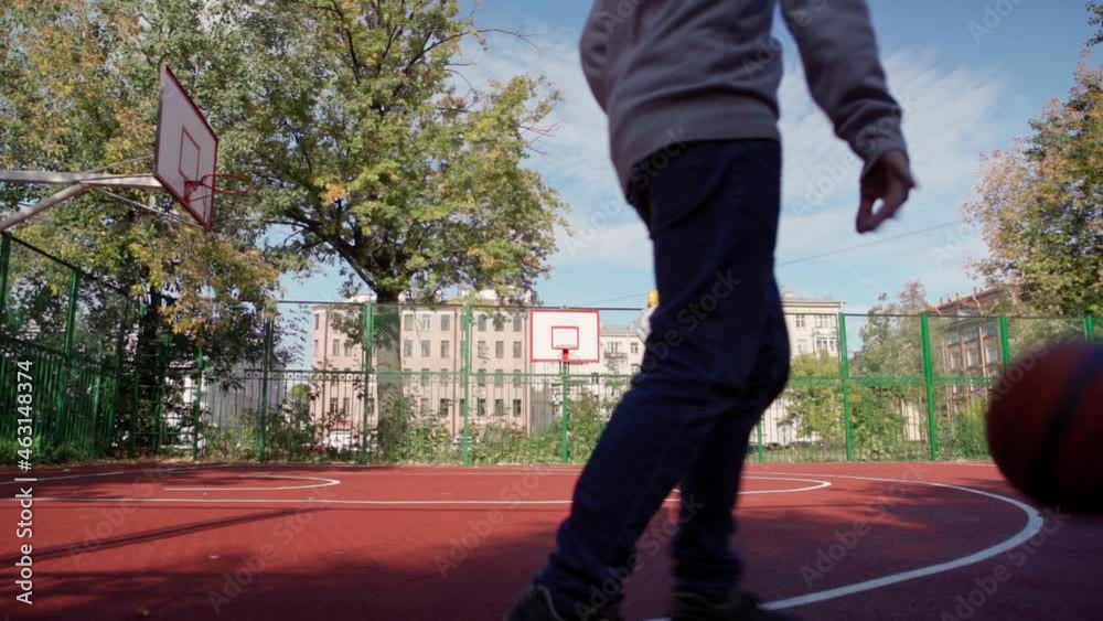 Side view wide shot of young man practicing basktball free throw in ...