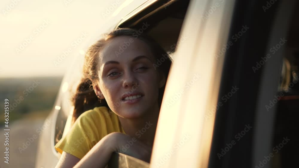 Child in car window. Family car trip. Child hair in wind. Girl looks ...