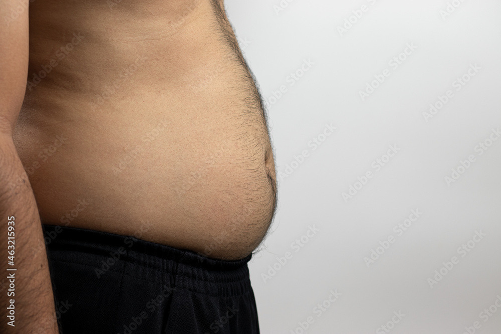 Side view photo of a shirtless man with a rather fat, bulging body and ...