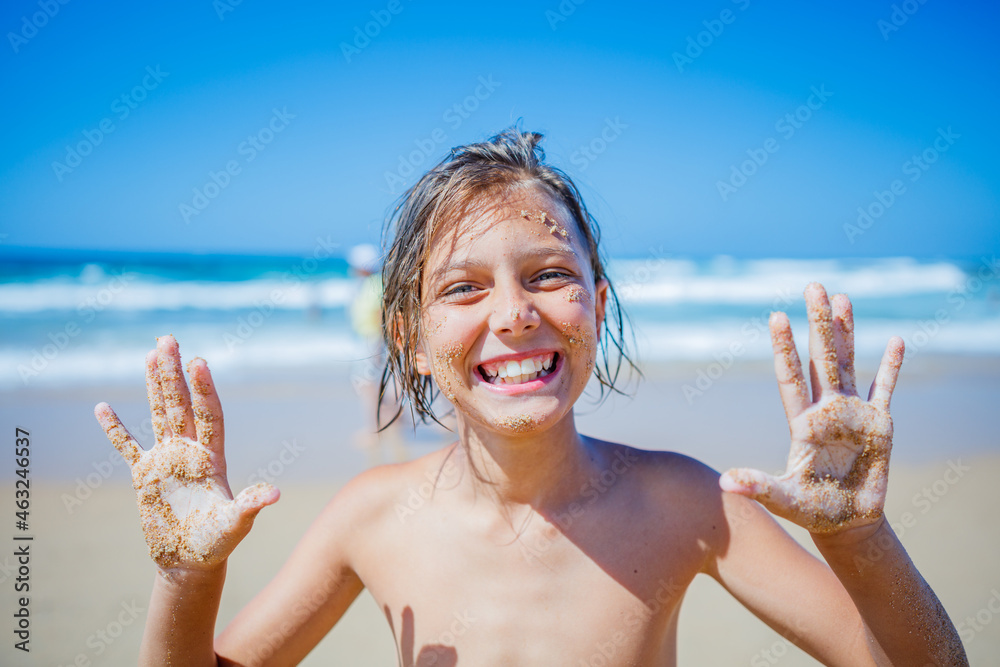 Young boy posing at the summer beach. Cute spectacled smiling happy 12 ...
